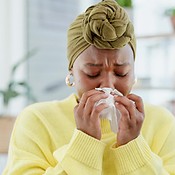 Black woman, sneeze and sick with tissue on sofa in home living room ...