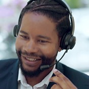 Call center, black man and happy while talking and typing on computer ...