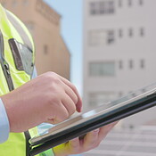 Hands, tablet and typing, architect and man in construction with ...
