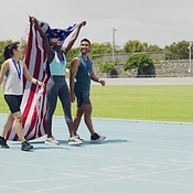 Team of patriotic athletes celebrating victory, walking and cheering on ...