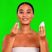 Green screen, makeup and woman with beauty blender and blush in studio ...