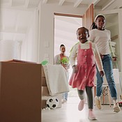 Children, moving in and running in family home with boxes and plants at ...