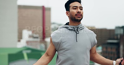 Asian man, fitness and jumping rope on rooftop in city for workout ...