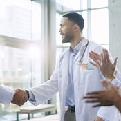 Happy, applause or doctors shaking hands for success, good job or bonus promotion in a hospital ...