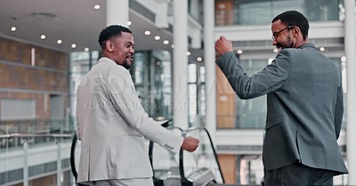Fist bump, business men back and happy handshake at office escalator ...