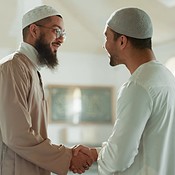 Muslim, handshake and people in mosque for greeting, conversation and ...