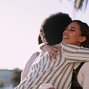 Education, women and hug with friends on college campus for learning ...