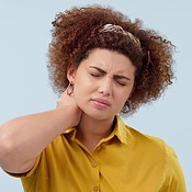 Neck pain, injury and woman in studio with stress, problem or muscle ...