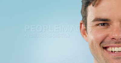 Half face, smile and mockup with a man on a blue background in studio ...