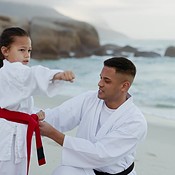 Beach, karate or training with a father and daughter together outdoor ...