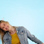 Happy, woman and whip hair in studio isolated on a blue background for ...