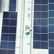 Overhead, solar energy and an engineering team on the roof of a ...