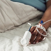 Iv drip, emergency and hand of patient in a hospital after surgery, treatment and operation in a ...