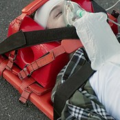 Emergency, injury and patient with oxygen mask on road for accident ...