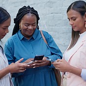 Friends, women outside workplace with phone for networking and ...