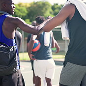 Basketball, men and friends with fist bump on a court for a game and ...