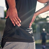 Sports, back pain and injury with black man on basketball court for ...