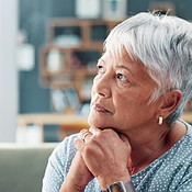Senior woman, thinking and living room with memory, grief and retirement home with anxiety ...