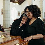 Grief, crying and women at coffin together at memorial service at ...