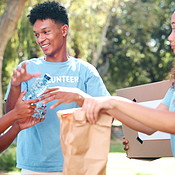 Donation, teamwork and volunteering people at park with water ...