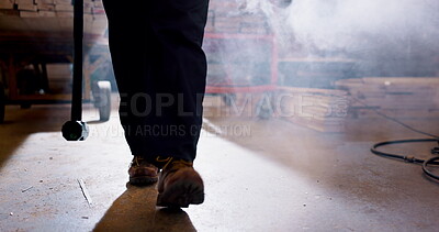 Worker, tool and person with hammer walking in workshop with smoke or ...