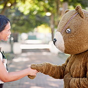 Bear, handshake and woman with costumer, greet and outdoor with hello ...
