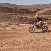 Motorcycle, speed and driver on sand trail with motorcross, power and ...