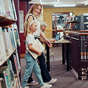 Library, mom and kid on smile for books, growth and development of ...