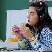Student, laptop and girl with fidget toy for adhd, stress and writing ...