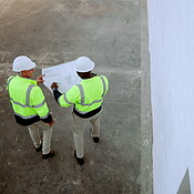 Construction, people and architect with paper in discussion for ...