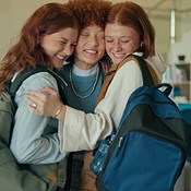 High school, students and happy girls hug for meeting, greeting and ...