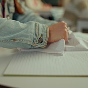 Classroom, frustrated and student tearing book on desk with exam stress ...