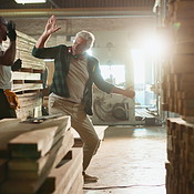 People, dancing and celebrate in woodwork factory, happiness with high ...