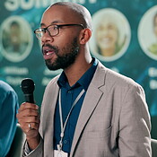 Stage, expert and speaker of science, talking and man with answer of ...