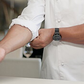 Chef, man and rolling for sleeves in kitchen of career with food ...