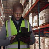 Black man, tablet and inspection in warehouse for distribution ...