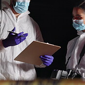 Forensic, team and documents with discussion at crime scene for ...