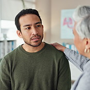 Sick, consultation and man by doctor in hospital with flu, cold or ...