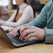 Research, typing and laptop with hands of student in library for ...