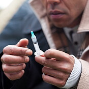 Homeless, man and hands with needle on syringe for illegal drugs ...