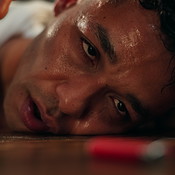 Drugs, addiction and face of man on table with powder, syringe and ...