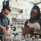 Clipboard, factory and distillery with team of people for distribution ...