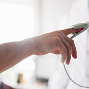 Man, finger and measure pulse in clinic, medical tool and easy ...