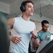 Man, fitness and running on treadmill with headphones for music ...