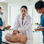 Doctor, students and CPR training in hospital with professional advice ...