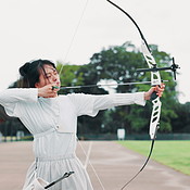 Archery, aim and woman with target training, outdoor practice and ...
