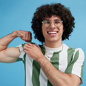 Man, face and kiss muscle in studio with flexing, smile and progress ...