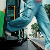 Legs, transport and people exit bus in road for morning commute, public ...