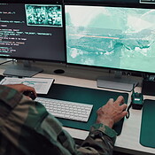 Man, soldier and typing with computer screen in control room, military ...