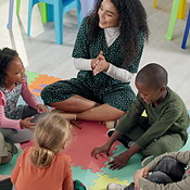 Sing, classroom and teacher with children on floor for music lesson ...
